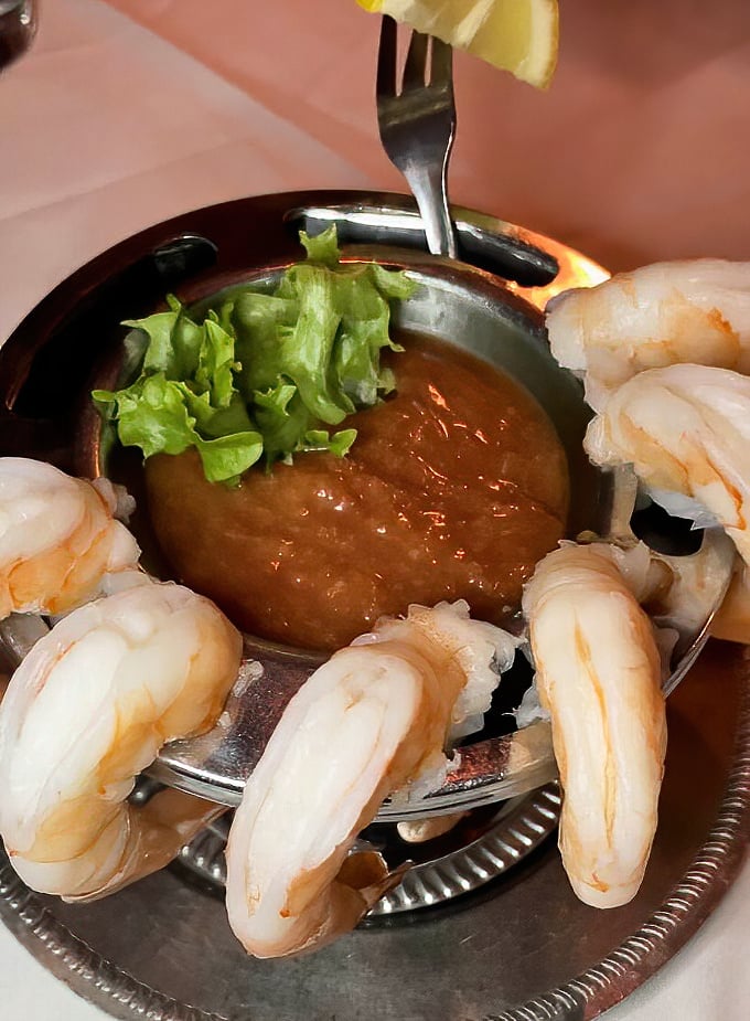Plump shrimp perched around a cocktail sauce center—like synchronized swimmers in a delicious aquatic performance that ends with a standing ovation from your stomach.