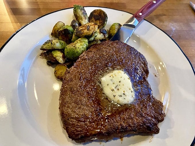 A perfectly seared steak crowned with herb butter slowly melting into a pool of flavor, with Brussels sprouts that even vegetable skeptics will devour.