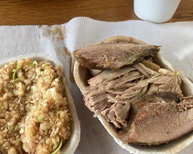 Meat and slaw in perfect harmony. The vinegar-based red slaw cuts through the richness of the pork like a culinary conductor.