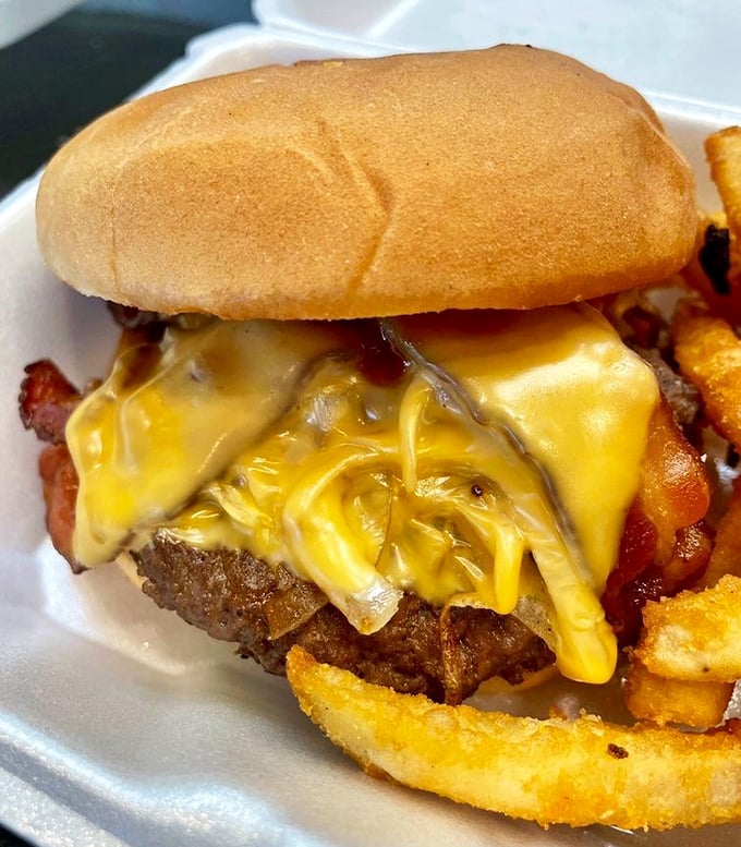 Cheese melting like Salvador Dalí's clocks over a perfectly charred patty. This isn't just a burger—it's performance art you can eat.