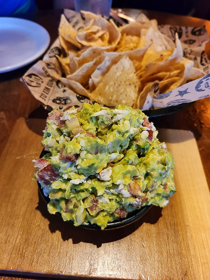Guacamole elevated from simple dip to table centerpiece—a vibrant, chunky mountain of avocado goodness that demands respectful demolition.