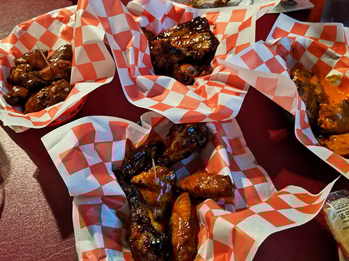 Wings nestled in checkered paper boats, glistening with sauce and promise. These aren't just appetizers—they're the opening act to a barbecue symphony.