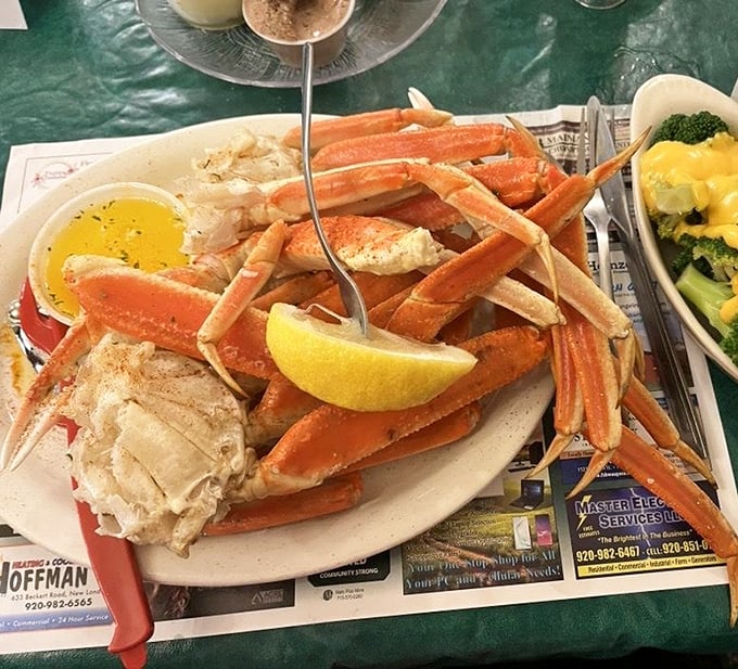 Snow crab legs arranged like a delicious puzzle, waiting to be solved with drawn butter as your trusty sidekick and a lemon wedge for moral support.