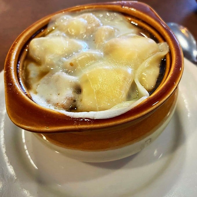 French onion soup that doesn't just warm your body but hugs your soul – a steaming crock of brothy bliss topped with melty cheese islands.