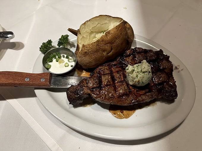 A baked potato the size of your fist, compound butter melting into a perfectly charred steak—this is happiness on a plate.