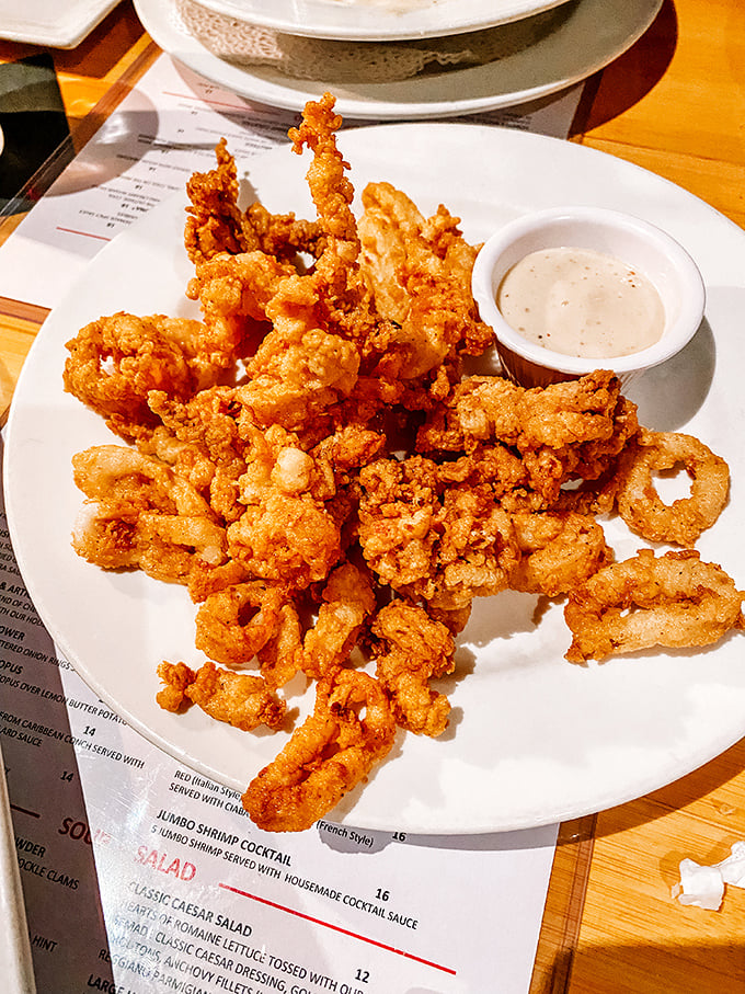 Crispy calamari that puts rubbery bar food to shame. Tender inside, perfectly crisp outside—the Goldilocks of seafood starters.