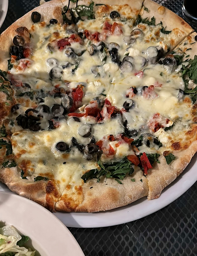 When vegetables get the VIP treatment: spinach, olives, and roasted red peppers nestled under a blanket of melted cheese that would make any pizza purist swoon.
