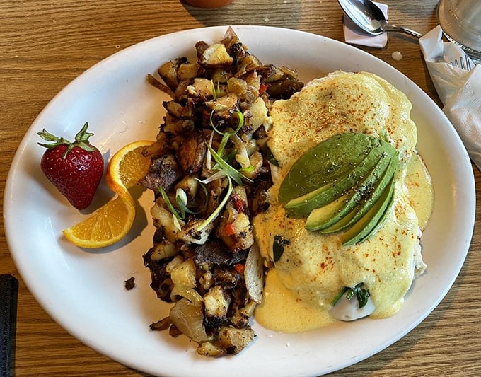 This isn't just breakfast, it's edible art. Hollandaise-draped eggs with fresh avocado slices—a California dream on an Oregon plate.