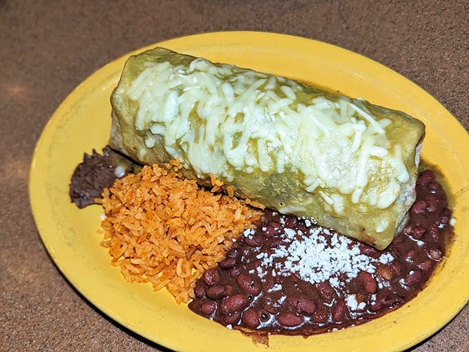A green chile burrito that's dressed for success with a blanket of melted cheese. The perfect rice-to-bean ratio is the unsung hero here.