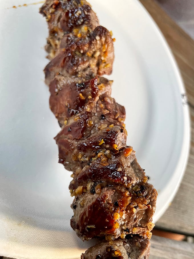 Meat on a stick—humanity's greatest culinary invention since fire itself. This glistening, caramelized beauty demands your immediate attention.