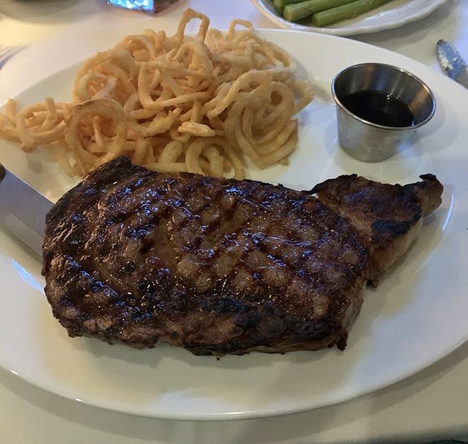 A properly cooked steak with a mountain of those famous onion strings—a combination that should be prescribed by doctors.
