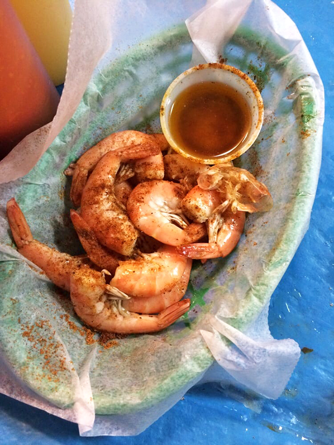These plump, spice-dusted shrimp aren't just seafood—they're little pink crescents of oceanic joy, waiting for their butter bath before their final destination.