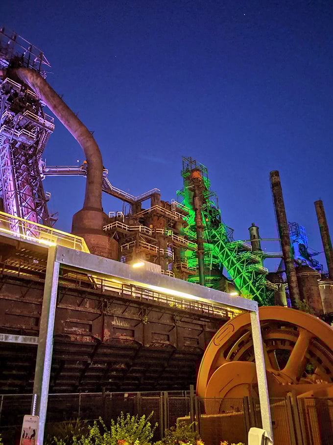 By night, the former Bethlehem Steel blast furnaces transform into a technicolor industrial cathedral, proving that sometimes a city's past can light the way to its future.