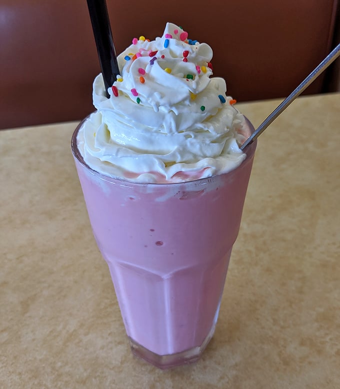 This strawberry milkshake isn't playing games – it's thick enough to require a spoon first, with sprinkles that remind you it's okay to feel like a kid again.