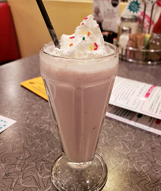 This isn't just a strawberry shake—it's summer vacation in a glass, complete with whipped cream mountain and sprinkle confetti.