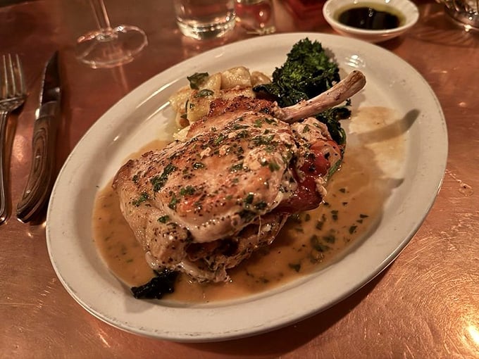 The legendary stuffed pork chop arrives like royalty in a pool of savory sauce—this is why reservations are Pittsburgh's hottest commodity.