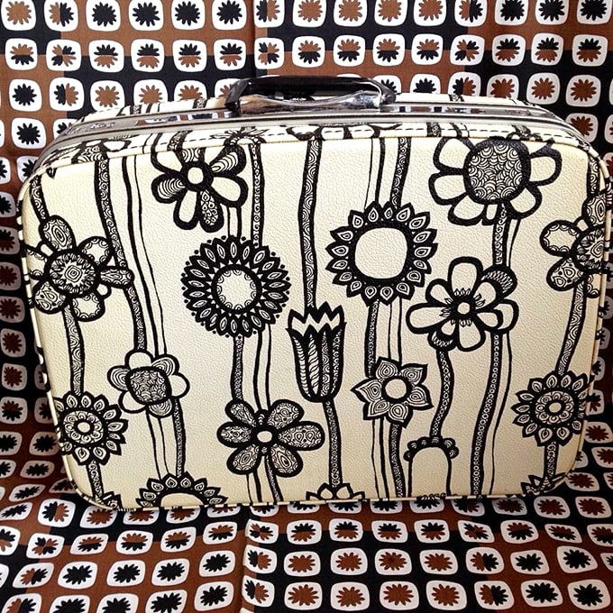 This flower-adorned vintage suitcase doesn't just carry clothes—it carries stories. Imagine the places it's been before landing in Chicago!