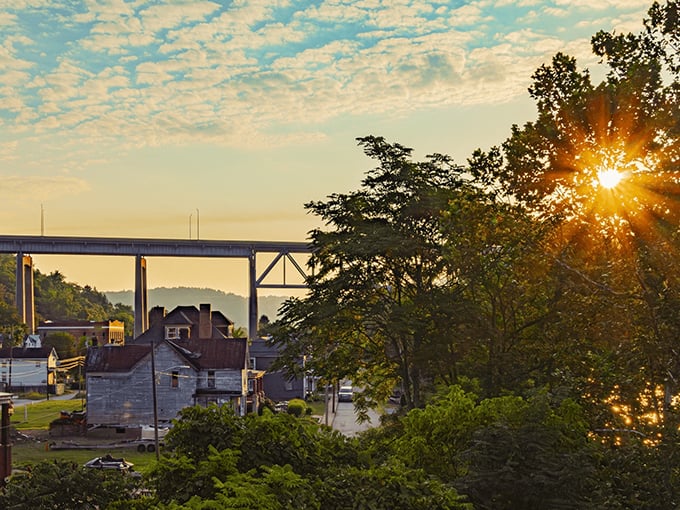 Golden hour bathes Brownsville in nostalgic light, silhouetting the bridge that connects communities across the Monongahela's steady flow.