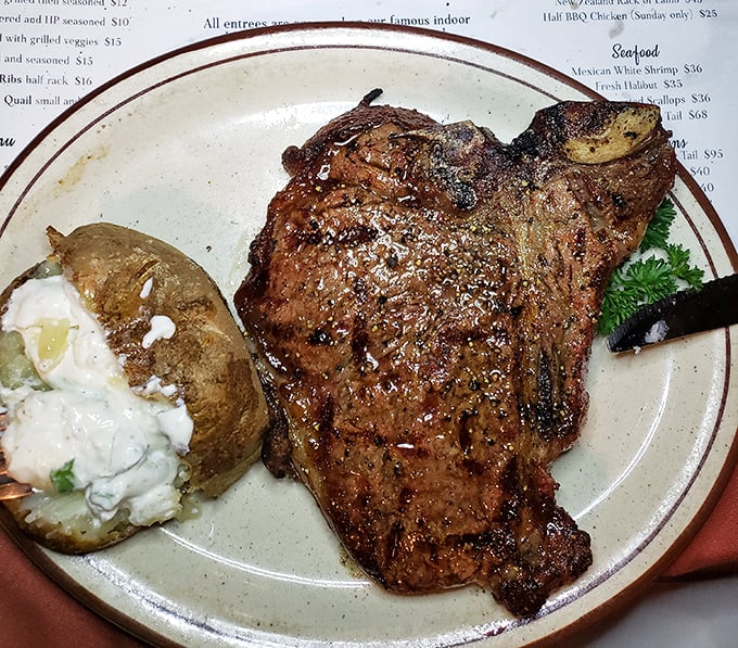 A steak so magnificent it deserves its own ZIP code. That loaded baked potato isn't just a side—it's a worthy companion on this flavor journey.