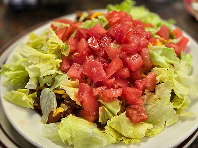 This taco salad isn't messing around – fresh lettuce supporting a mountain of diced tomatoes. The kind of salad that makes you feel virtuous while still being delicious.