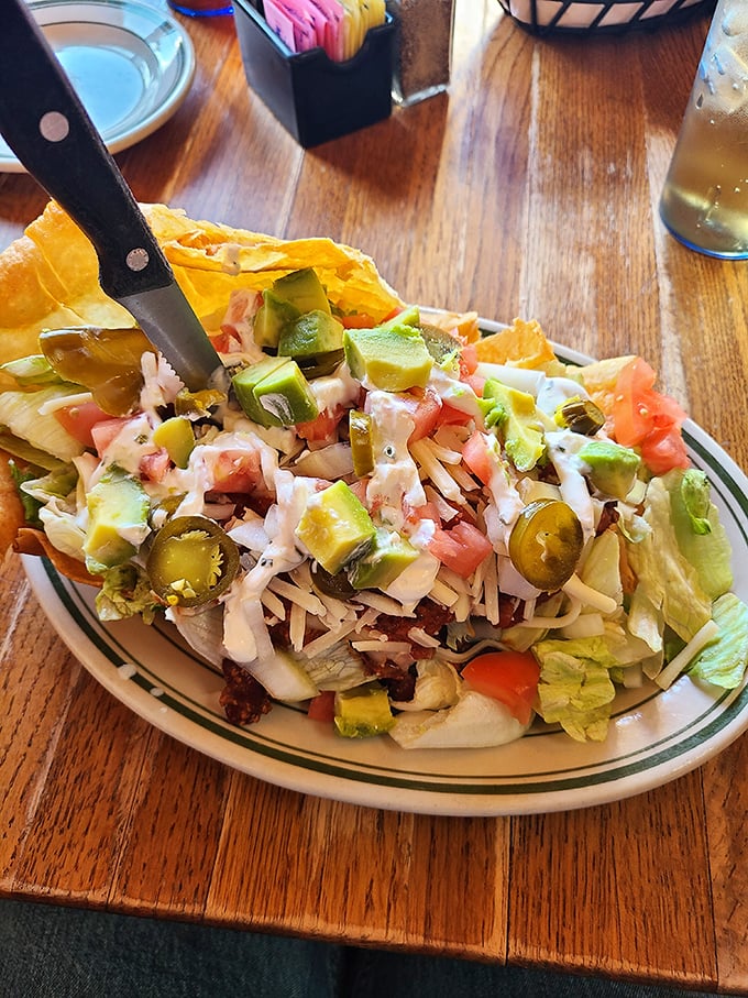 The legendary taco salad in all its glory. A crispy tortilla bowl cradles layers of flavor that locals drive miles to experience—worth every bite and napkin.