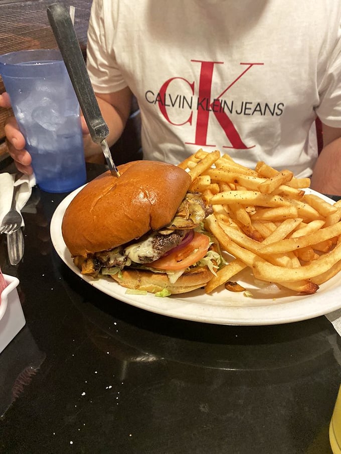 This isn't just a burger – it's edible architecture with layers of flavor stacked between a perfectly toasted bun. The fries aren't bad either!