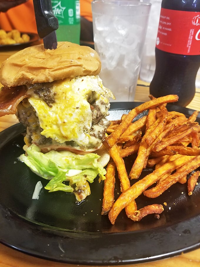 Meet the Full Monte burger—a towering achievement that makes you wonder if you should eat it or apply for a building permit first.