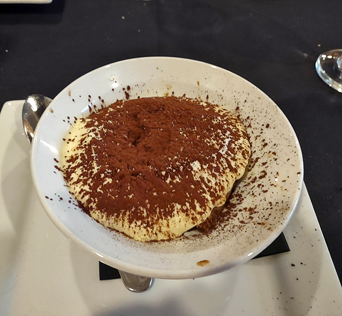 The tiramisu arrives like a cloud dusted with cocoa—the perfect sweet punctuation mark to end your culinary sentence.