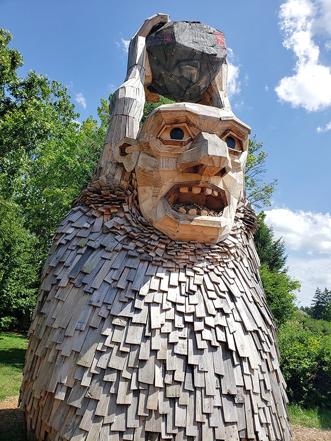 This wooden giant appears to be contemplating the meaning of life—or possibly wondering why humans keep taking selfies with him.