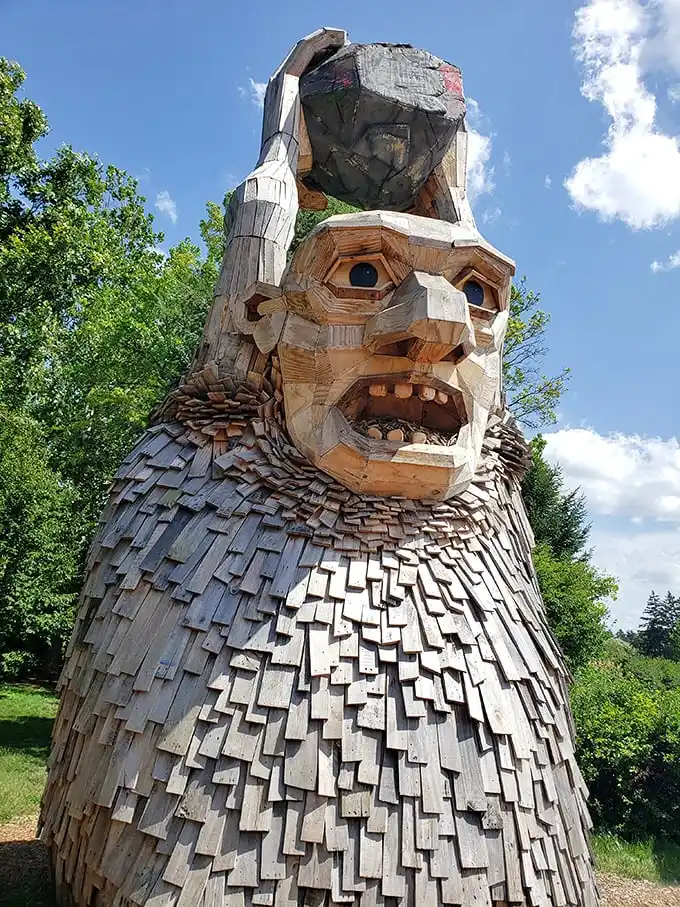 This wooden giant appears to be contemplating the meaning of life—or possibly wondering why humans keep taking selfies with him.