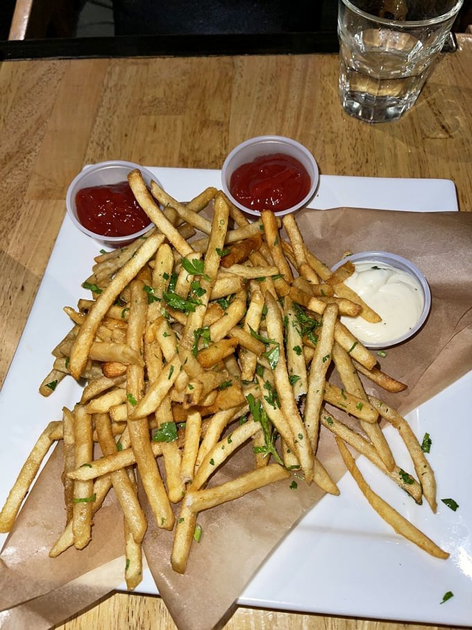 These aren't just fries; they're crispy, herb-flecked vehicles for the trio of dipping sauces that will have you plotting your next visit.