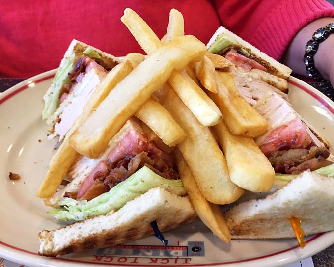 The club sandwich—architecture you can eat, where each layer is perfectly positioned between toast triangles that somehow hold the whole beautiful mess together.