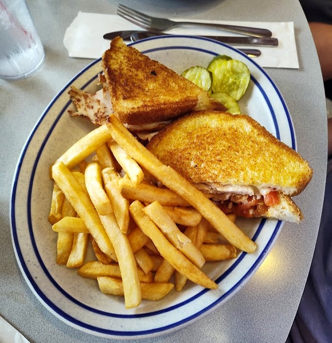 A turkey melt that understands the importance of proper cheese-to-bread ratio. Paired with those crispy fries, it’s the lunch equivalent of a warm hug.