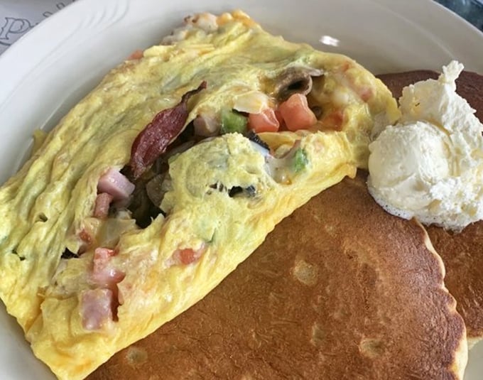 This isn't just an omelet—it's a vegetable apartment complex where peppers, ham, and cheese have moved in together and become best friends.