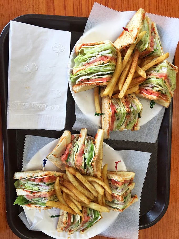 Club sandwiches stacked higher than a Philly skyscraper, with crispy fries standing guard. Lunch perfection achieved.