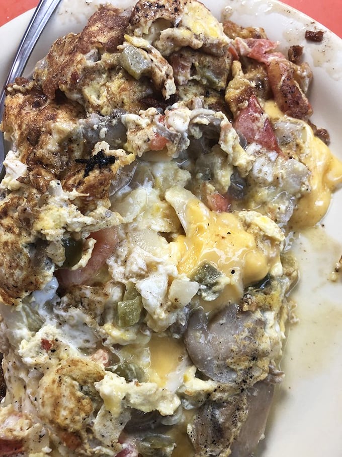 This isn't just an omelet—it's a masterpiece of morning architecture, where vegetables and cheese create a symphony of breakfast perfection.