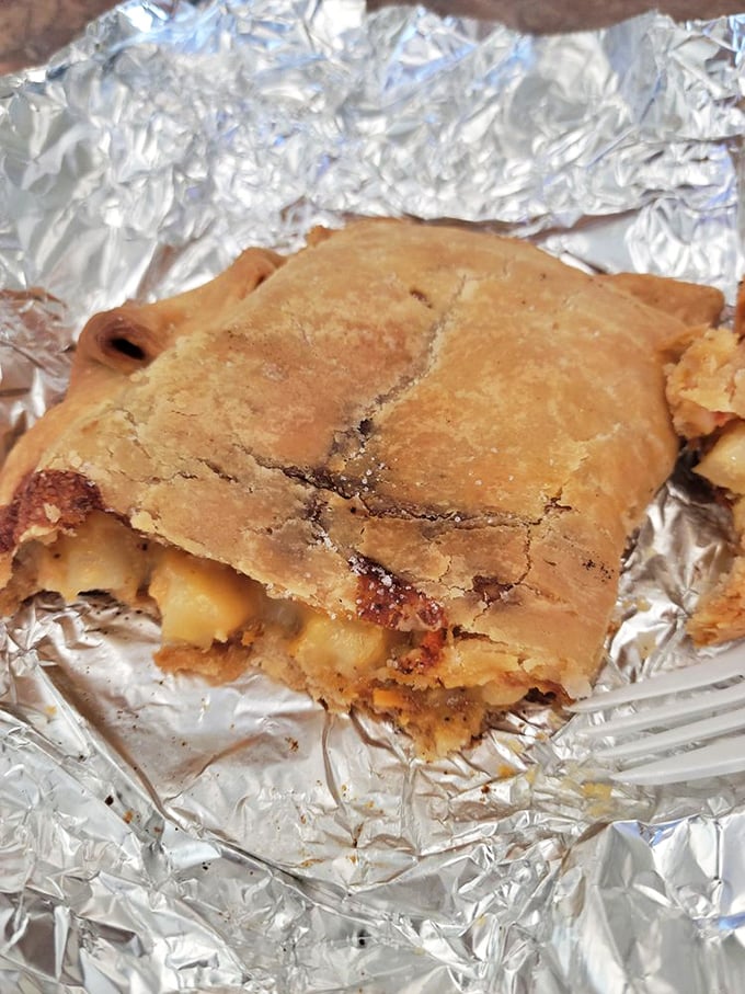 One bite reveals the treasure within—tender chunks of filling peeking through the flaky, golden crust of pasty perfection.
