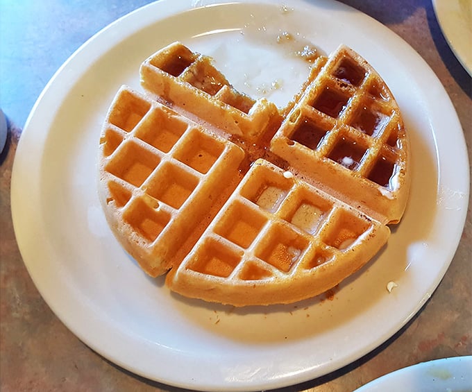 Golden waffle perfection awaiting its maple destiny – those perfect squares practically begging to be filled with syrupy goodness.