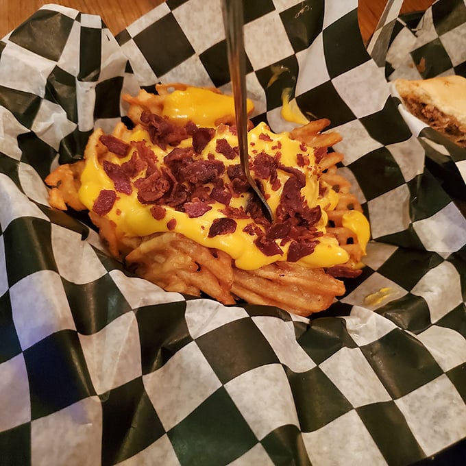 Cheese fries with bacon bits that make you question why you ever bothered with plain fries. Diet culture's kryptonite in a checkered basket.