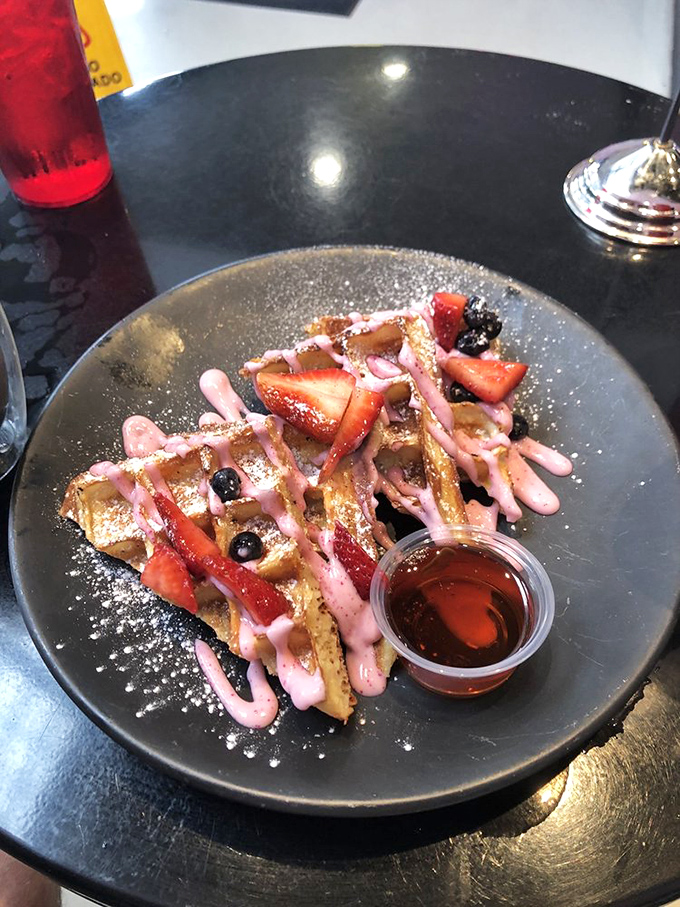 Waffles that dresses for the occasion—berry drizzle, fresh fruit, and a dusting of powdered sugar create breakfast worth getting out of bed for.
