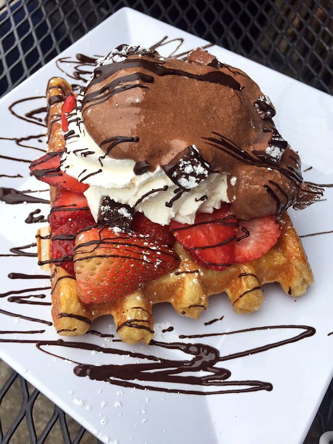 This isn't just a waffle—it's an architectural masterpiece of chocolate, strawberries, and whipped cream. Breakfast or edible art? Both.