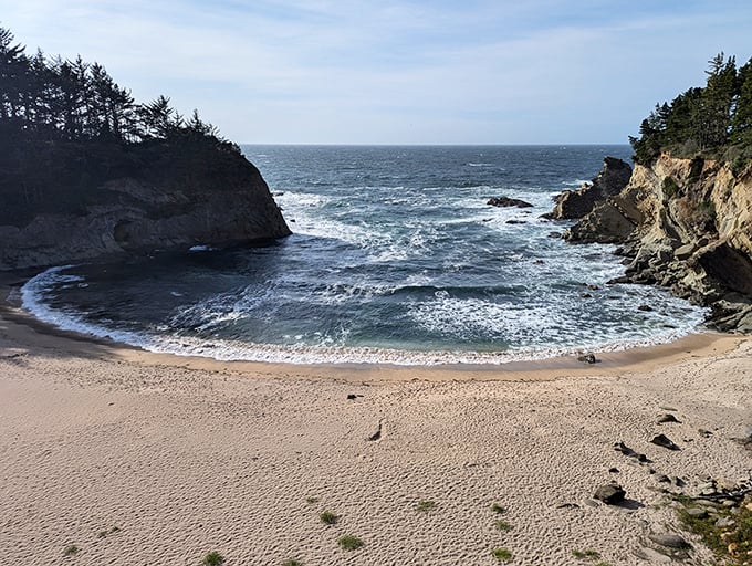 The perfect crescent of sand nestled between protective cliffs – nature's version of being hugged from both sides.