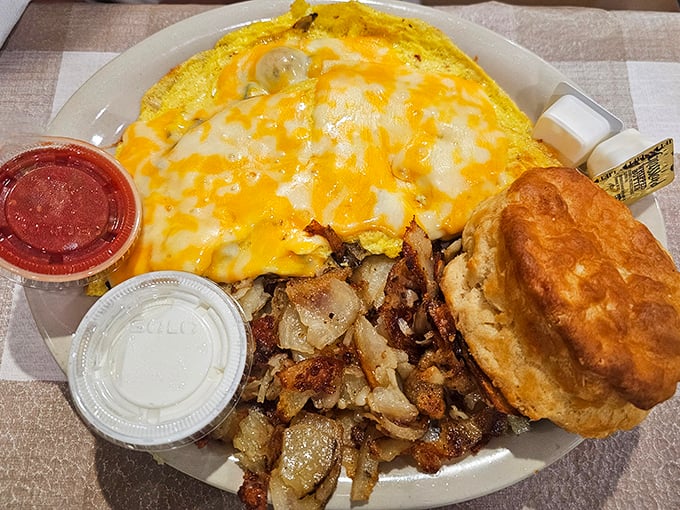 Breakfast nirvana: a cheese-blanketed omelet alongside home fries and a biscuit that could convert a carb-avoider faster than you can say "pass the butter."