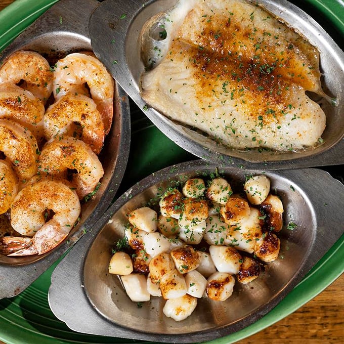 Perfectly seasoned fish and shrimp nestled in metal dishes like treasures in a pirate's chest. The kind of seafood that makes you question all previous life choices.