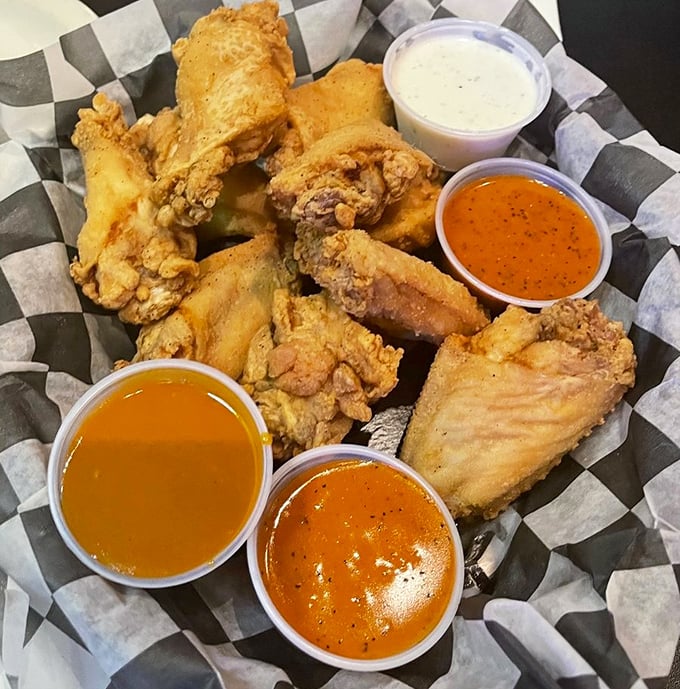 Wings that don't need a sporting event excuse—crispy, saucy perfection served with enough dipping options to keep you happily experimenting.