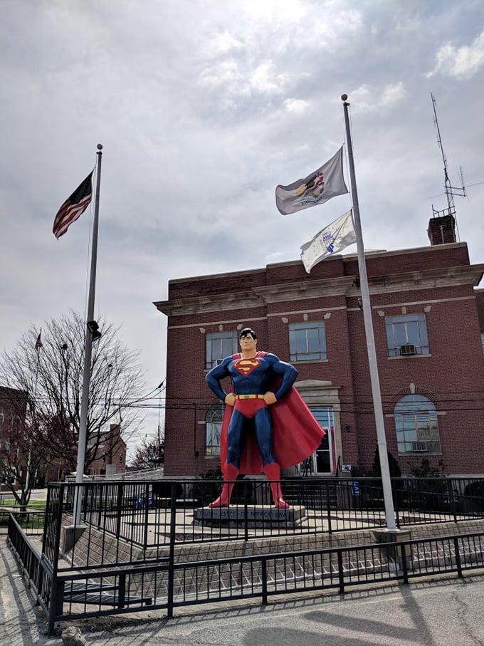 The statue's stern profile suggests he's keeping a watchful eye on Metropolis—or possibly eyeing that ice cream shop across the street.