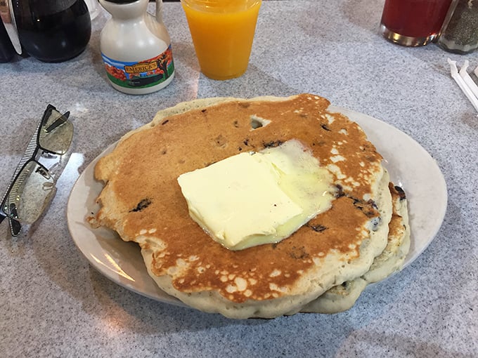 Blueberry pancakes that could convert a waffle loyalist—fluffy, golden discs topped with a generous slab of butter melting into every nook.