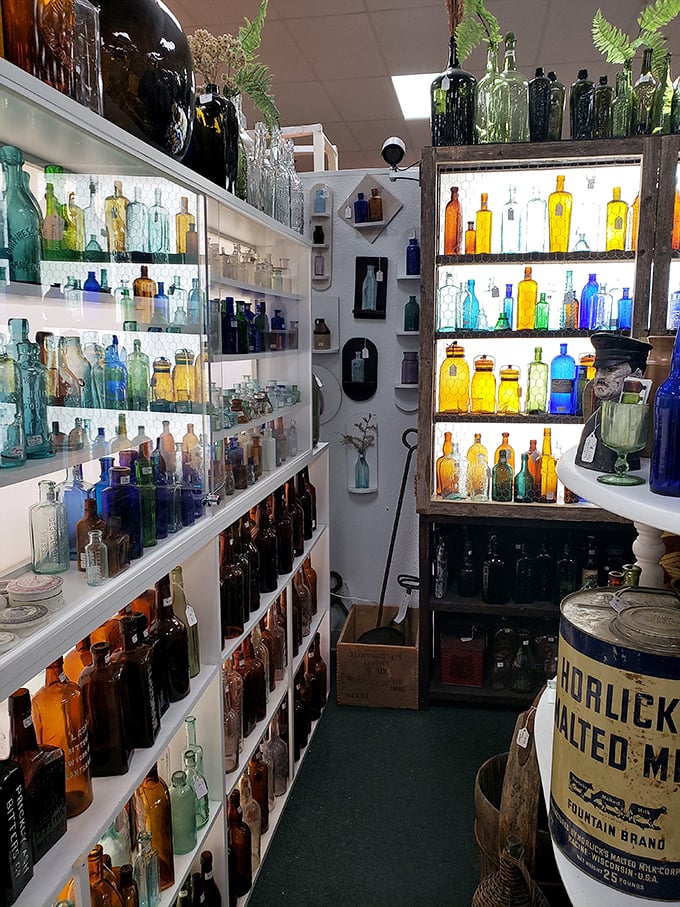 A rainbow of vintage bottles catches the light like liquid jewels—each one with stories to tell about potions and tonics past.