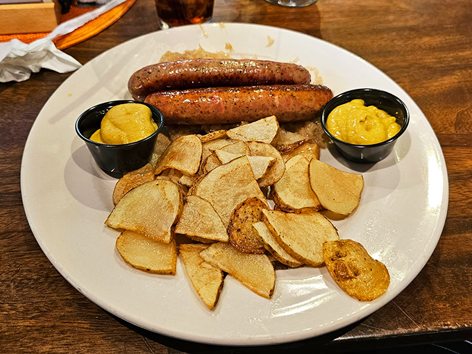 Two plump sausages stand proudly beside golden potato wedges—a simple yet profound reminder that Germans really understand comfort food.