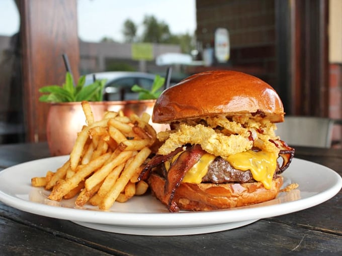 Not just a burger—it's an architectural marvel of beef, bacon, and melty cheese that requires both hands and absolutely zero dignity to consume.